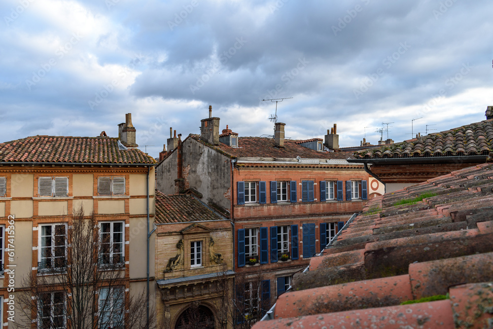 Old houses of Toulouse historic town centre, clay roof tiles and a ...