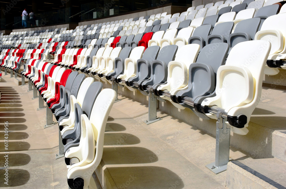sloped seating area detail. sport stadium. curving rows of colorful red ...
