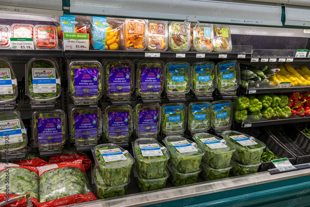 Lush green romaine lettuce and spring mix in clam shells with green and ...