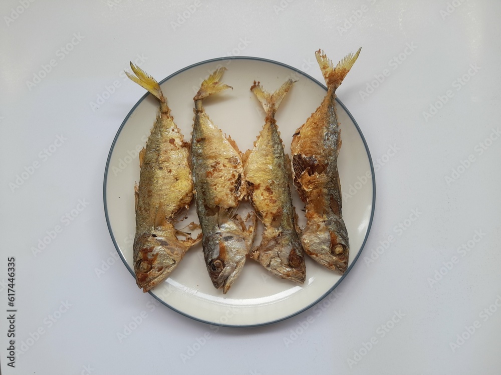 fried mackerel food (ikan kembung) on plate top view on white ...