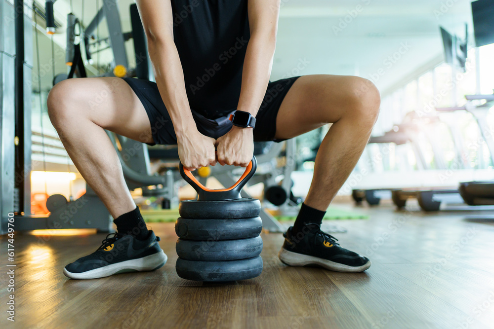 Poster Handsome Asian man practicing a squat weight training exercise ...