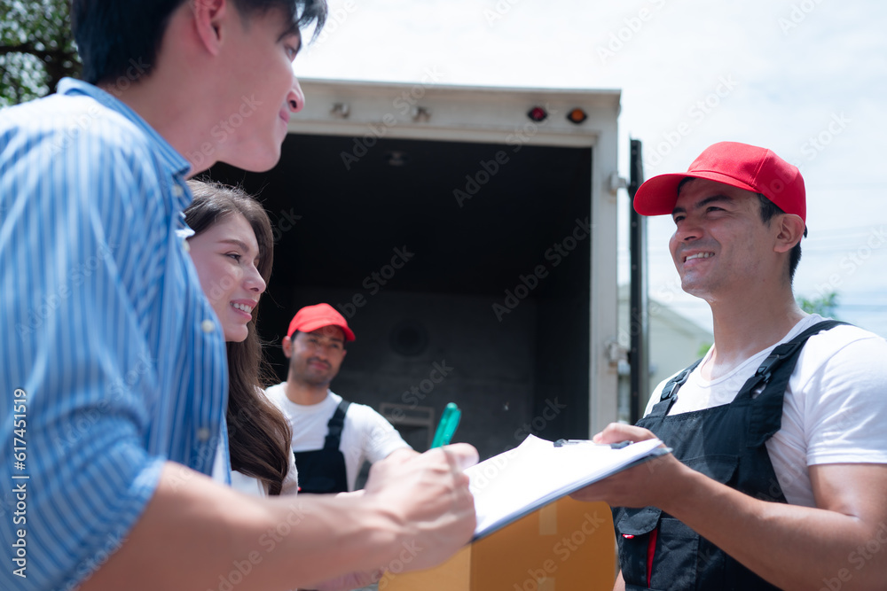 Delivery man handing over parcel boxes to customer in front of truck ...