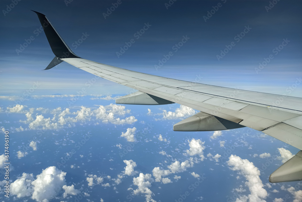 View through airplane window of commercial jet plane wing flying high ...