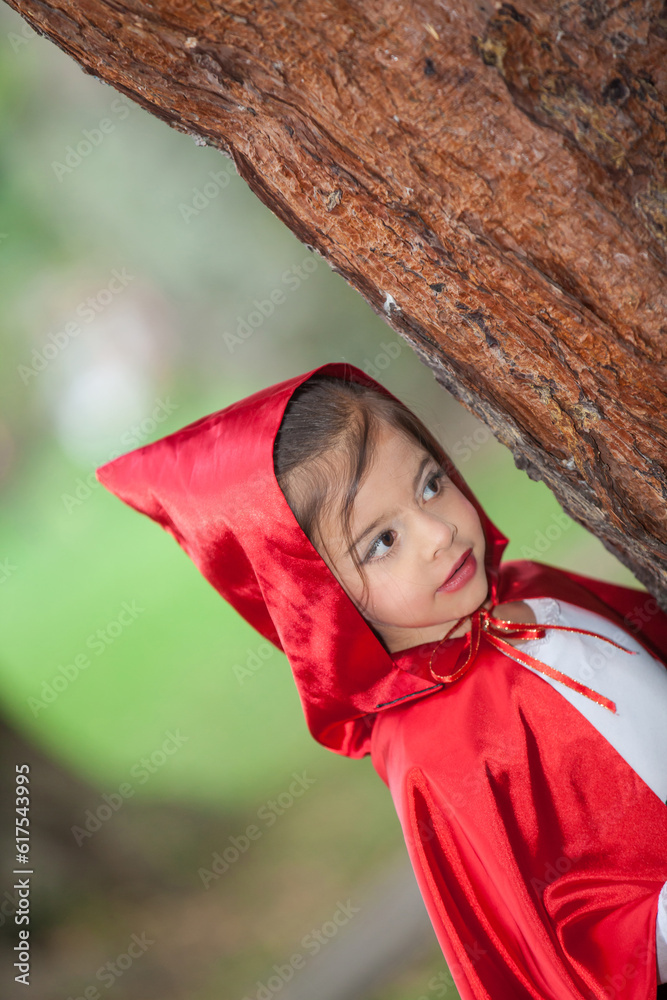 Sweet girl wearing a Little red riding hood costume. Real family having ...