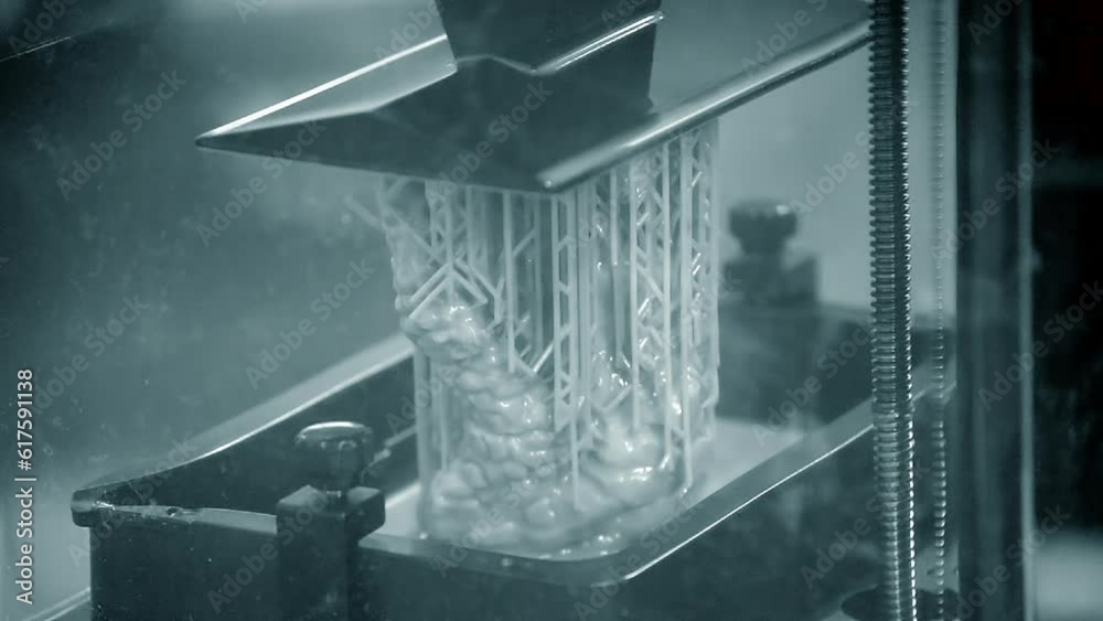 Working of photopolymer sla 3D printer. Platform with building object ...