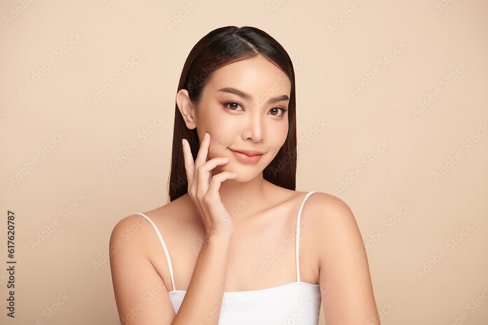 Beautiful young asian woman with clean fresh skin on beige background ...