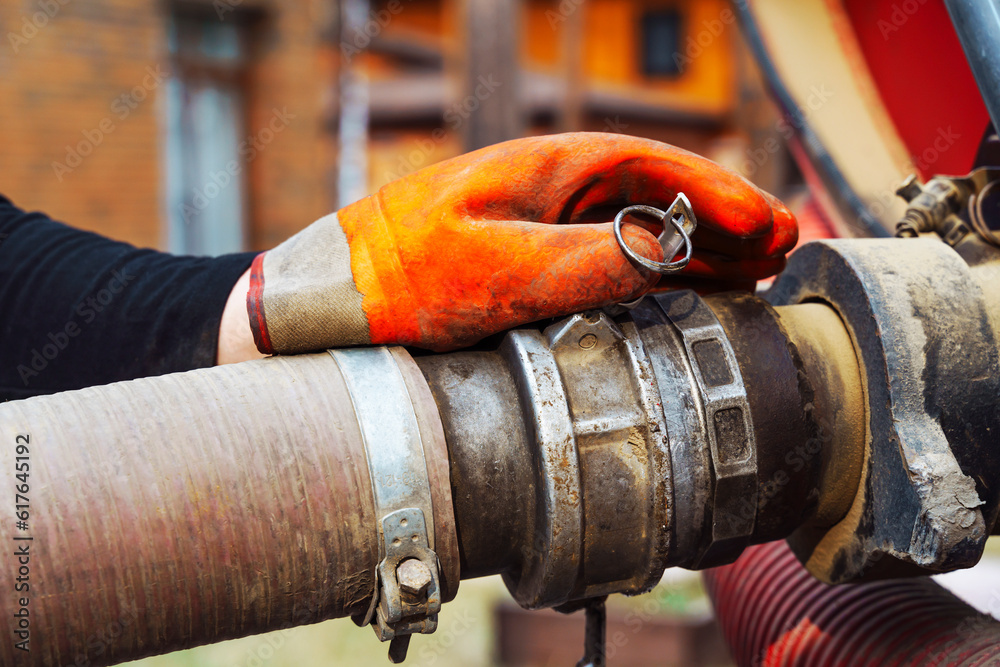 Photo a hand connects a suction hose to a sewage tanker truck, Sergey ...