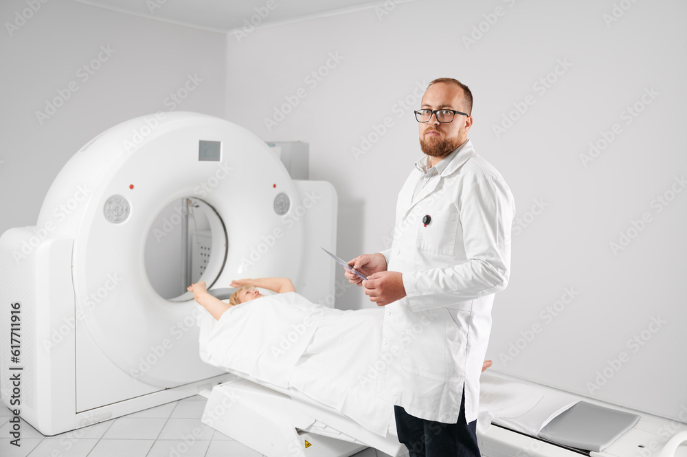 Medical computed tomography or MRI scanner. Portrait of doctor holding ...