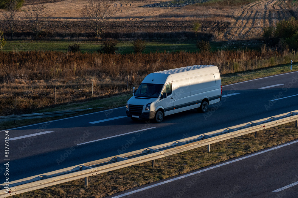 White delivery van on the highway. White modern delivery small shipment ...