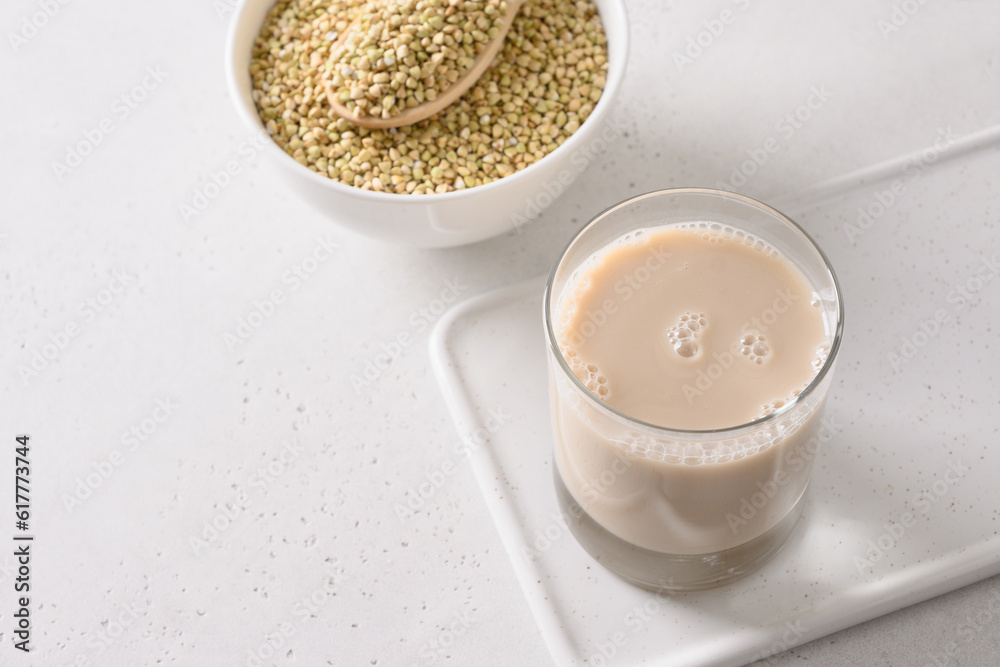 Alternative grain green buckwheat milk in glass on white background ...