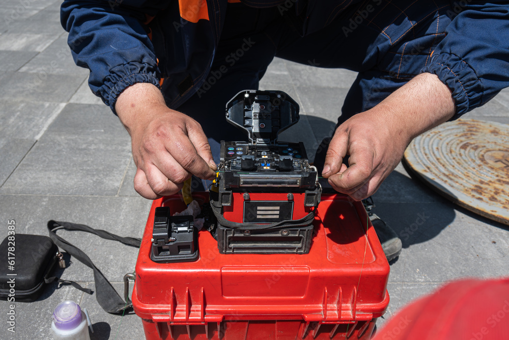 Master installer performs soldering of fiber optic lines, internet ...