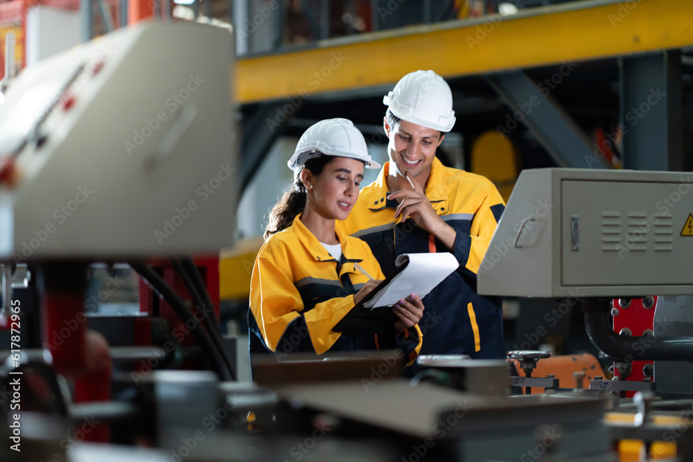 Two professional engineer,worker,technician use clipboard discuss work, walk in steel metal ...