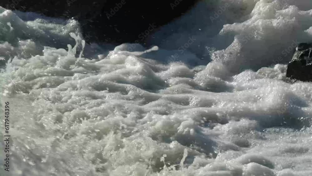 Beautiful Slow Motion flowing water over a cascading bridge forming ...