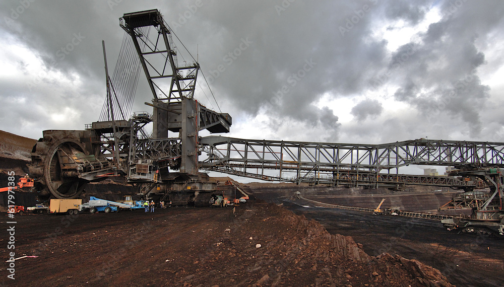Open cut mining maintenance worker, welding bucket dredge teeth on ...