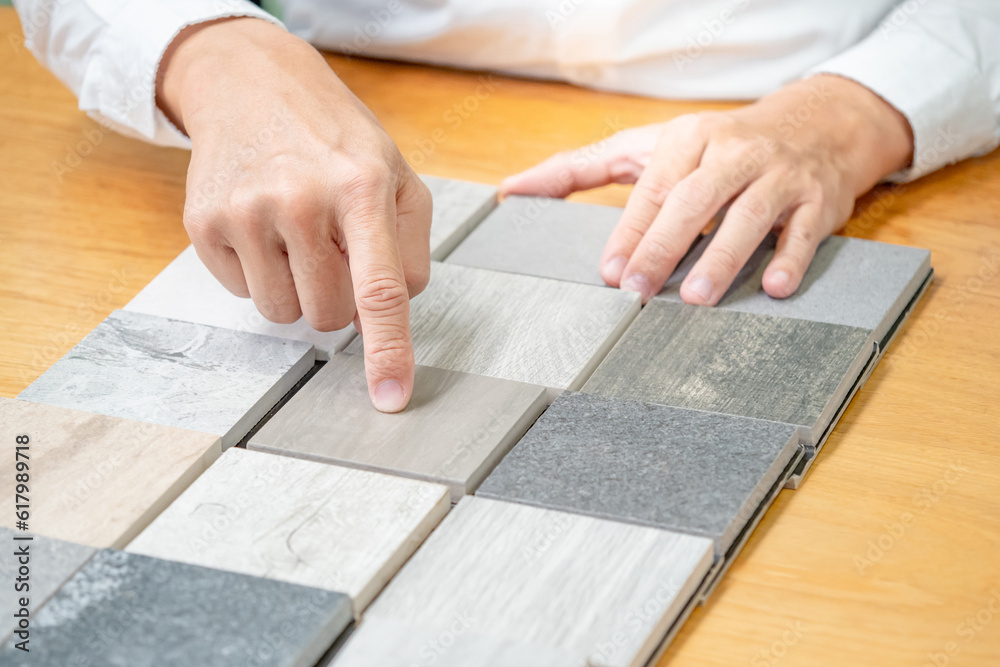 Architect hand choosing and pointing at stone material samples or tile ...