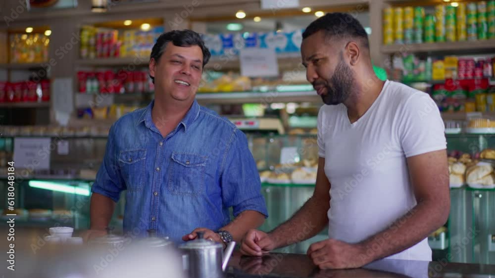 Two diverse Brazilian friends interacting at deli counter cafeteria ...