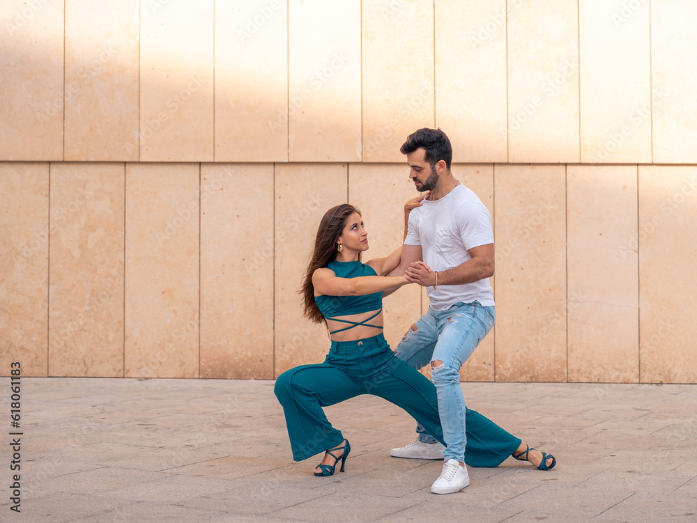 Dancing couple performing a dance pose in the street - Zouk dance ...