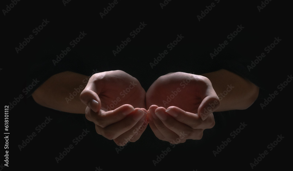 hand with open palm is waiting for help on black background. blank ...