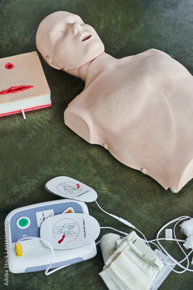 high angle view of CPR manikin near wound care simulator and automated ...