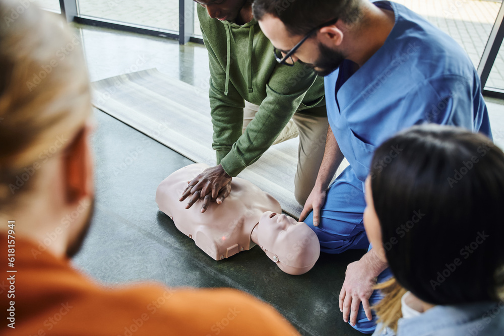 african american man practicing chest compressions and cardiopulmonary ...
