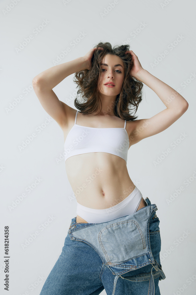 Pretty young brunette woman with curly hair, slim body, posing in top ... Pretty young brunette woman with curly hair, slim body, posing in top ...