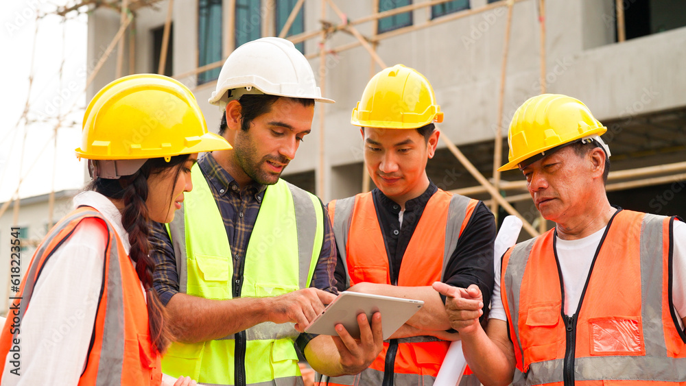 Civil engineers team with safety hard hat working together at ...