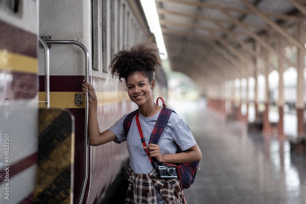 Traveler african asian american woman getting in a train to hop on ...