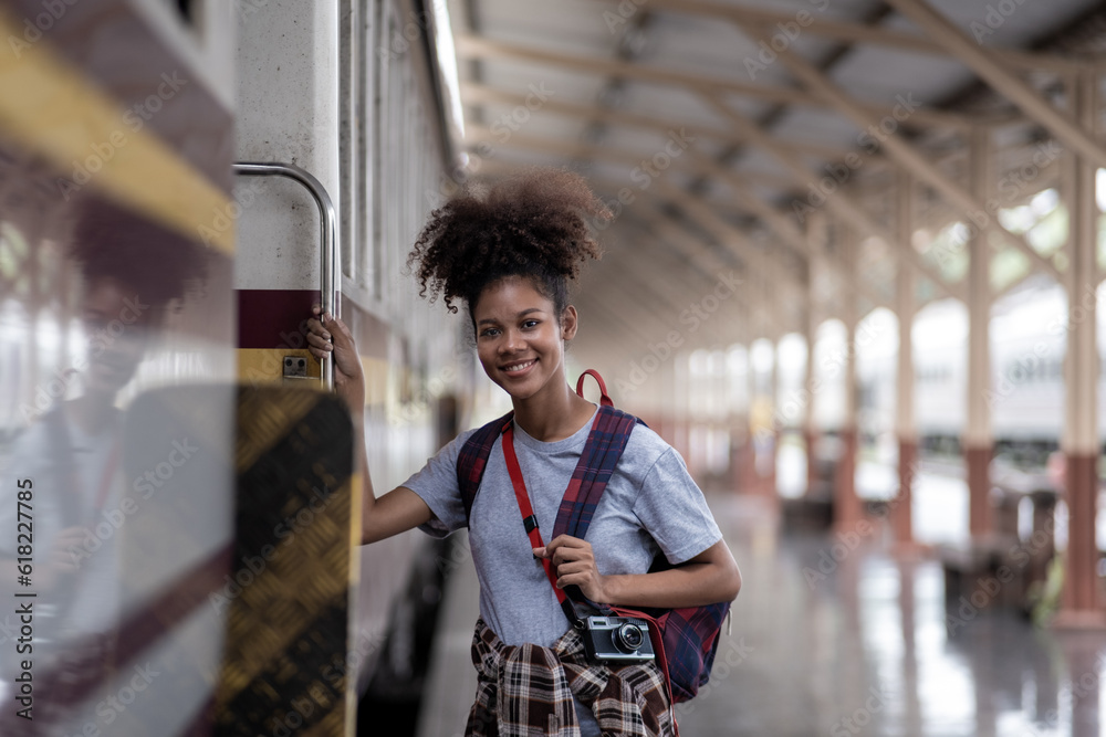 Traveler african asian american woman getting in a train to hop on ...