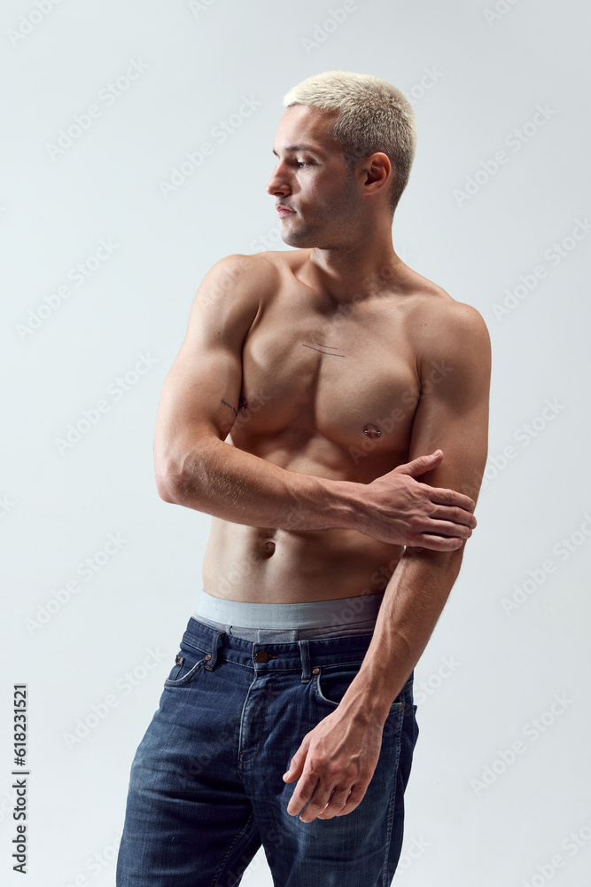 Portrait of handsome young man with muscular relief body posing ...
