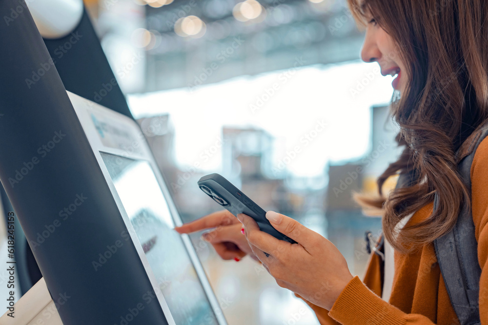 Closeup hands of asian woman using self check-in machine at the airport ...