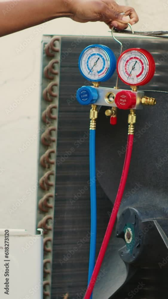 Vertical video Qualified electrician starting work on busted air ...