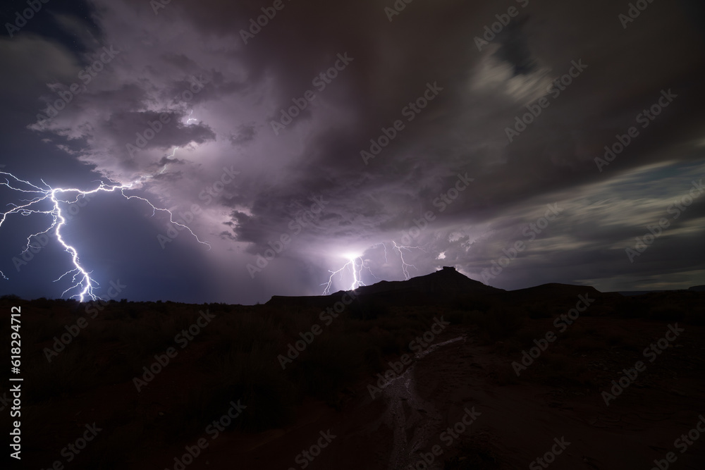 Dramatic bolts of lightning fill the night sky while a summer monsoon ...