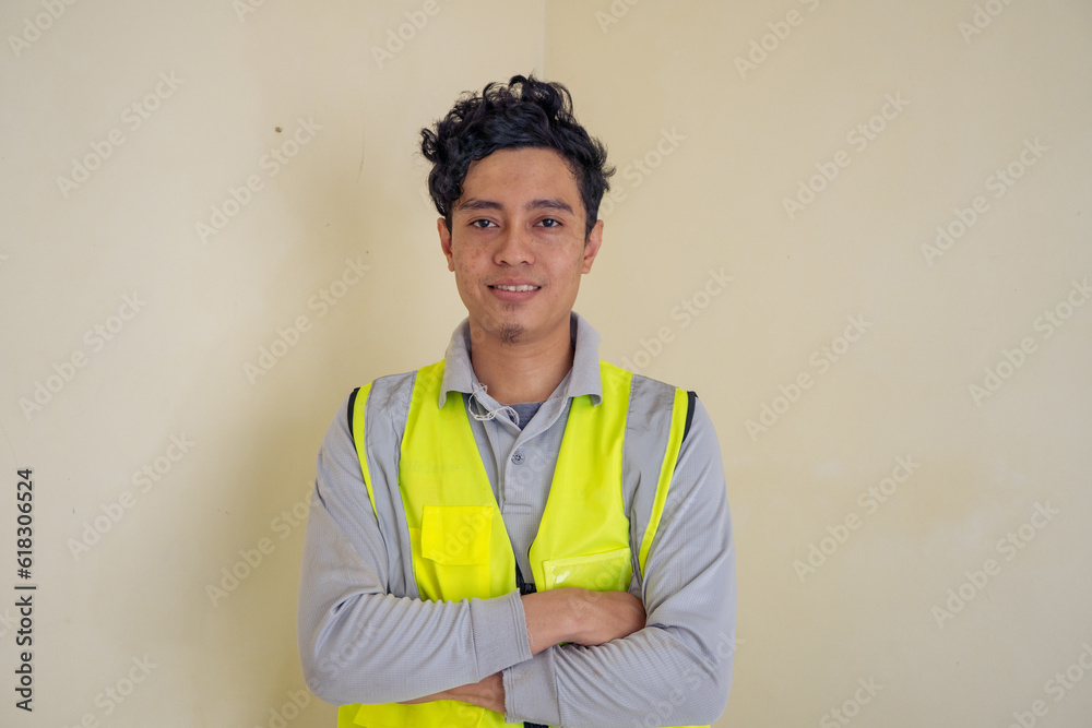 Young construction guys wear the wearpack and helmet with smile pose ...