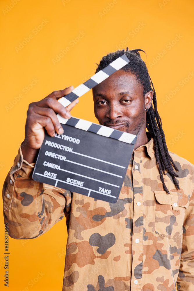 Attractive film director holding clipper board to cut scenes in movie ...