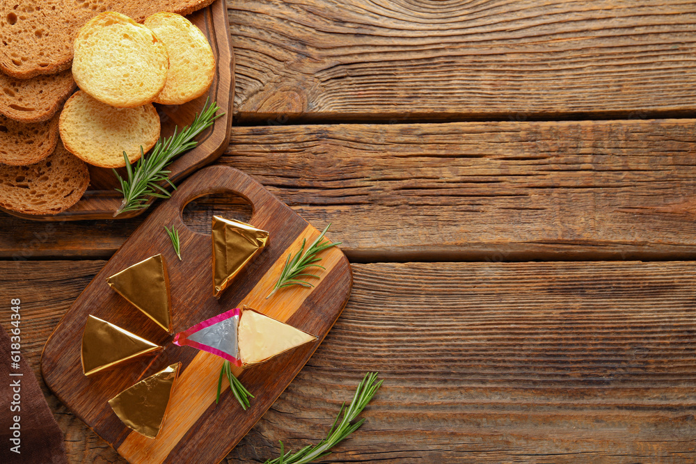 Boards with croutons and triangles of tasty processed cheese on wooden ...
