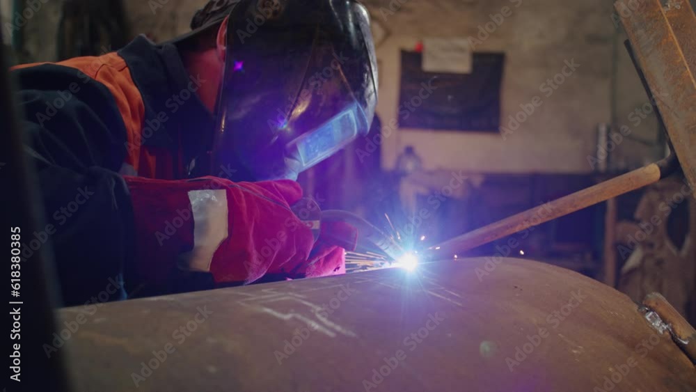 Explore the mesmerizing dance of sparks and flashes as a skilled welder ...
