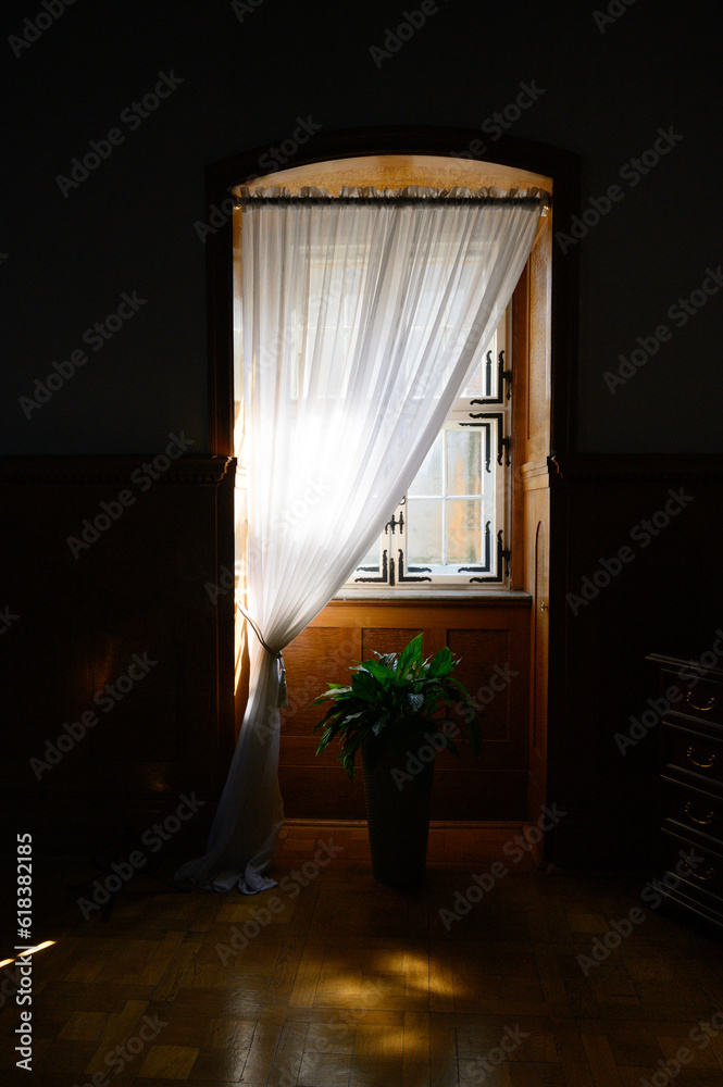 Dark room with light coming through the window through the curtain ...