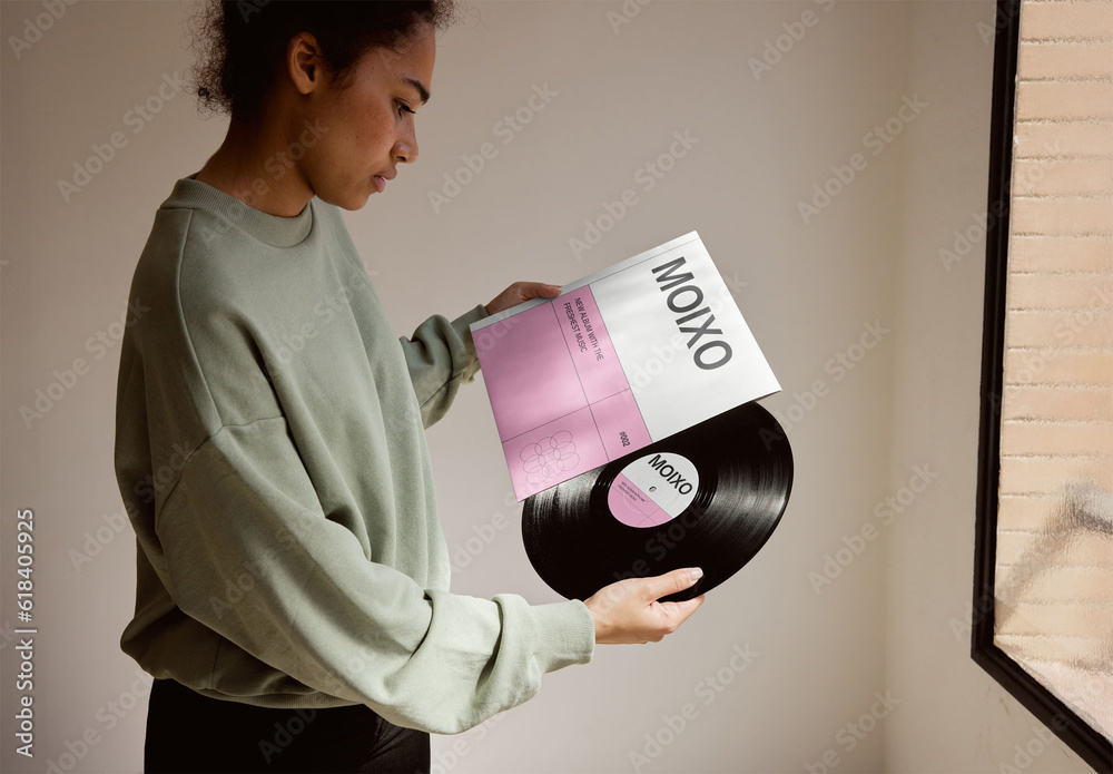 Mockup of person looking at LP vinyl record with customizable album ...