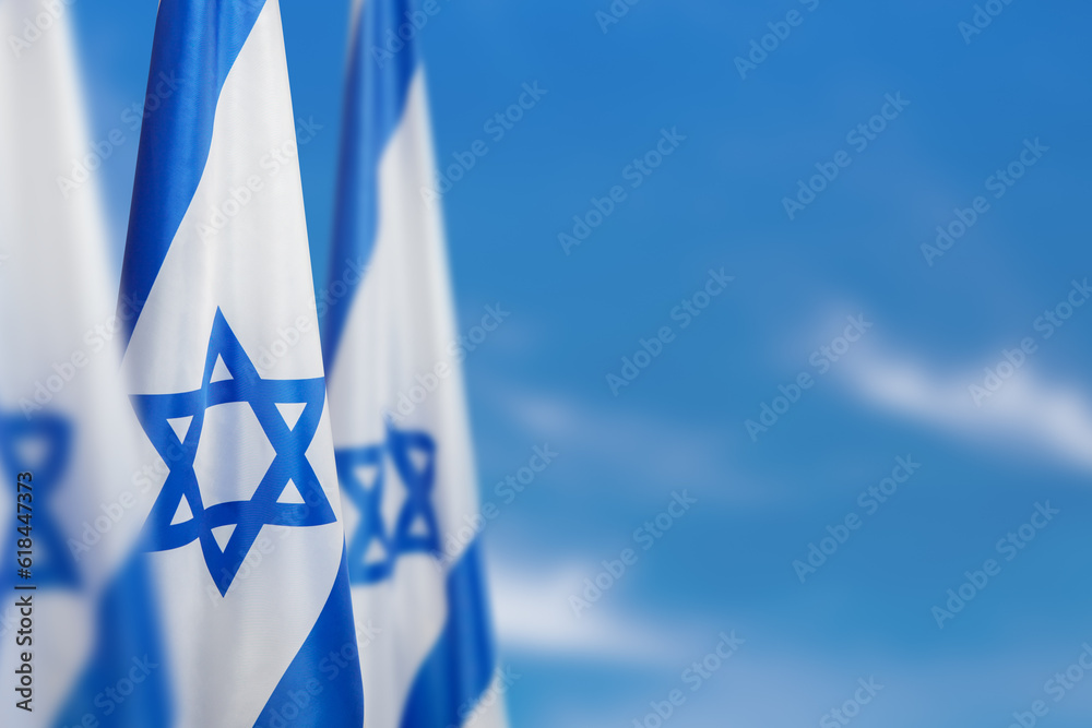 Israel flag with a star of David over cloudy sky background. Patriotic ...