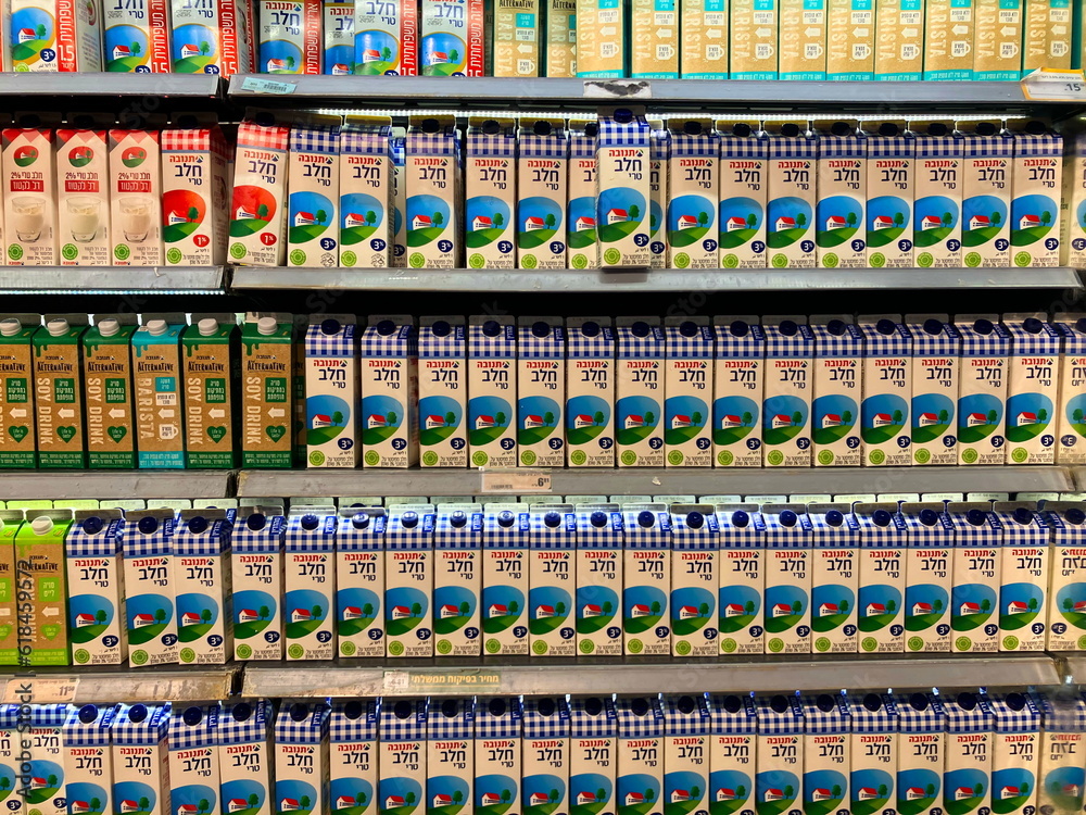 Israeli supermarket, dairy products.Showcase with milk. Milk in tetra ...