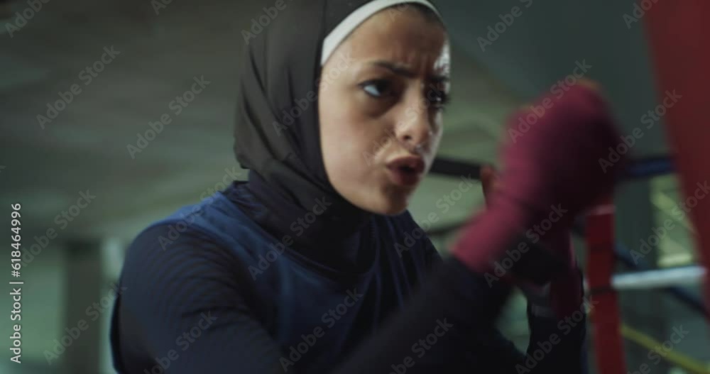 Portrait of Muslim Hijabi Girl Practicing her Boxing in a Gym, Throwing ...