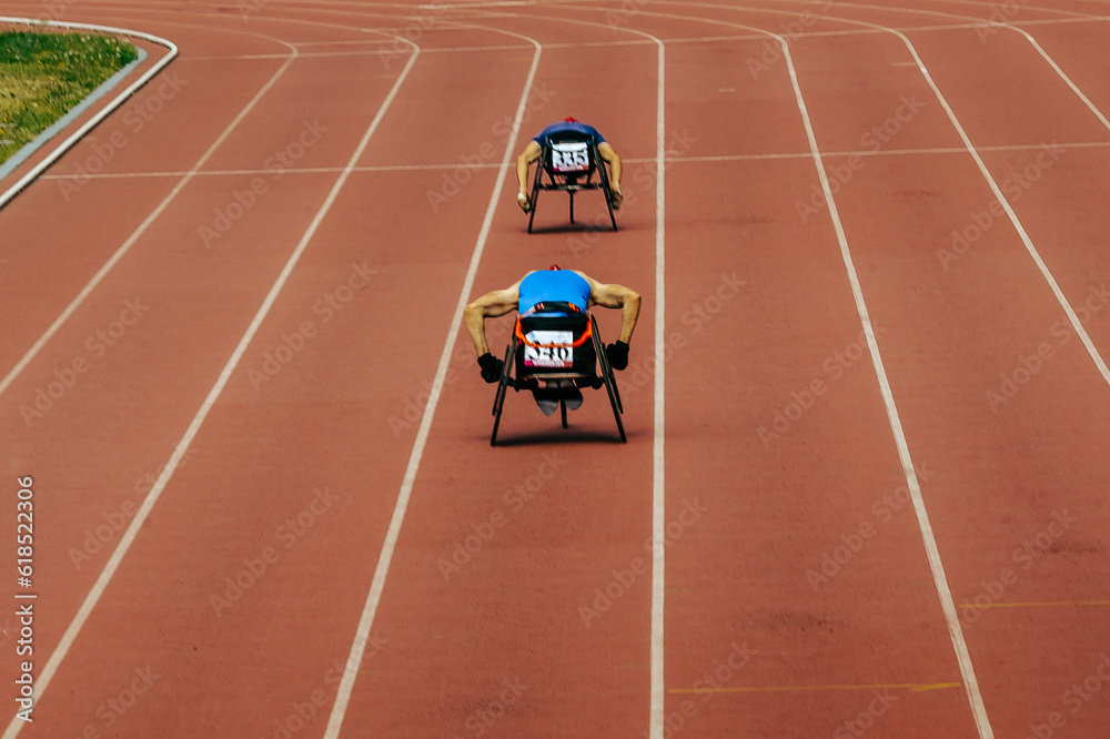 two athletes in wheelchair racing race track stadium in para athletics ...