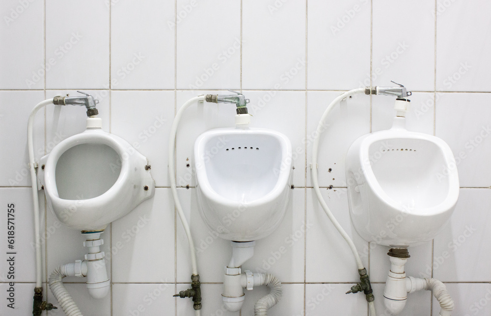 Row of outdoor urinals for a men's public toilet. 3 male urinals.Public ...