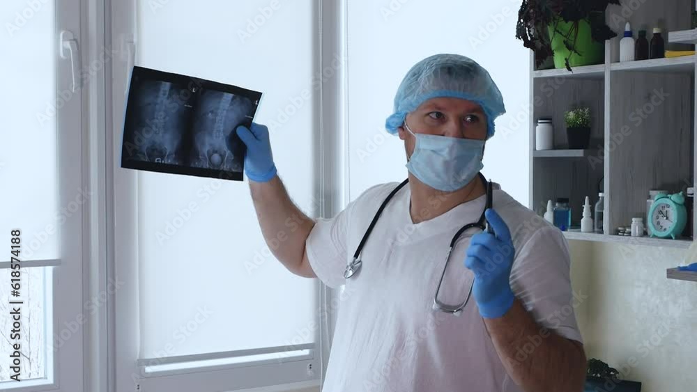 Calculus 8 mm in the ureter on x-ray in the doctor's hands. Doctor ...