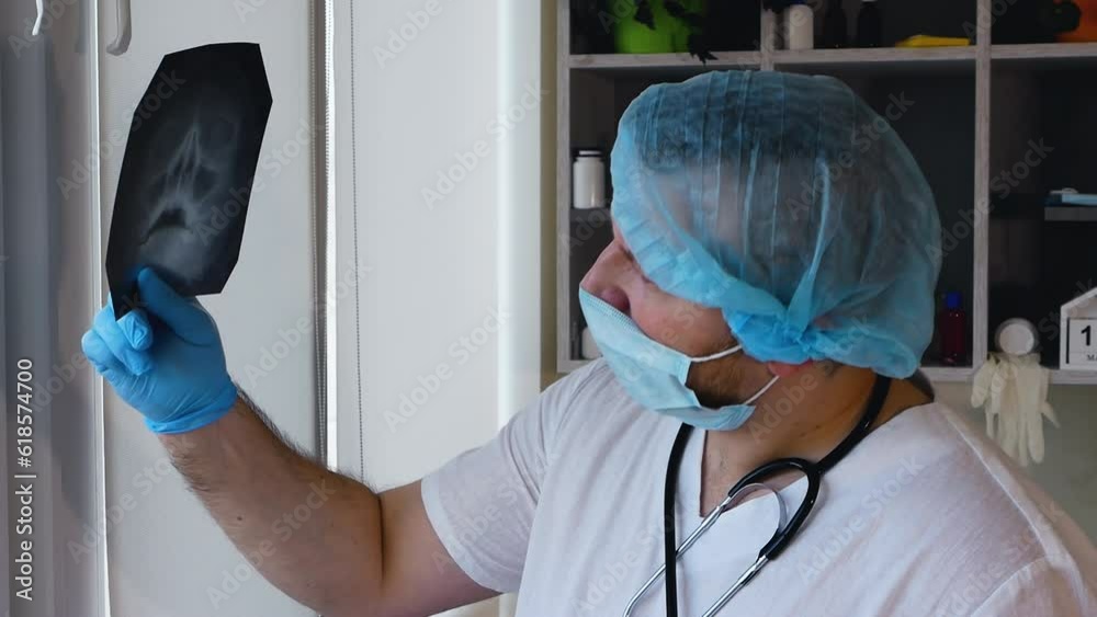 A young neurosurgeon analyzes the human cranial brain in a hospital ...