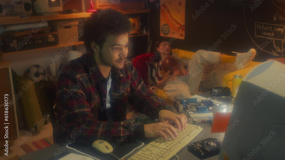 High angle shot of young Middle Eastern programmer typing on desktop ...