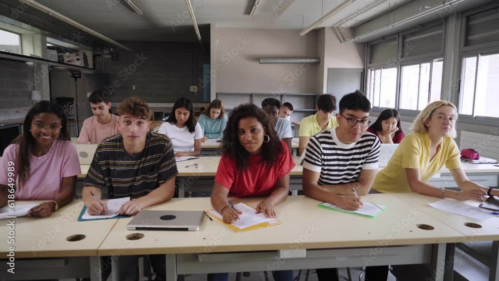 Concentrated group of college students sitting in the classroom taking ...