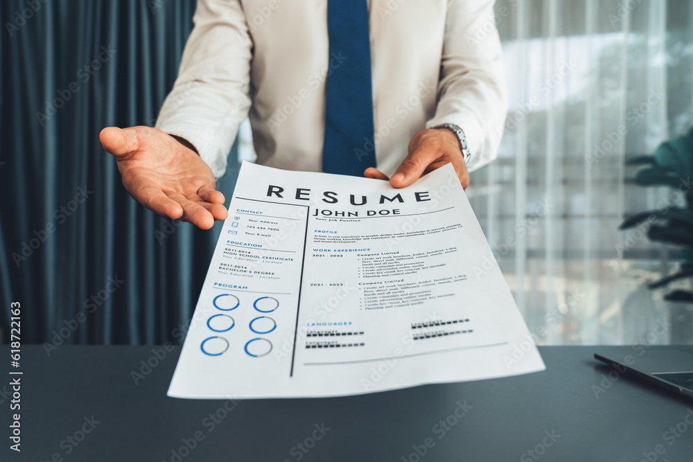 Confident man wearing suit in formal office, hand holding resume paper ...