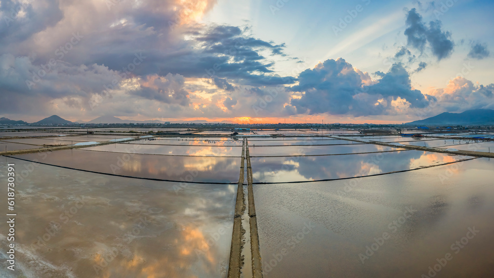 Field and Sea salt pile pyramid ready for harvest in salt farm. Sea ...