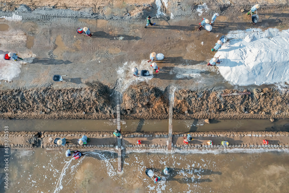 Field and Sea salt pile pyramid ready for harvest in salt farm. Sea ...